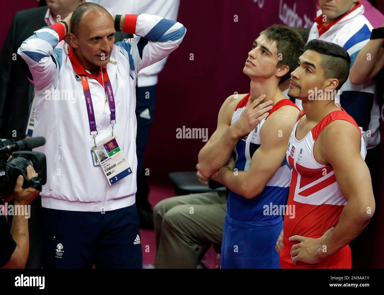 Britain's coach Eddie van Hoof holds his head as Britain's gymnast Max ...
