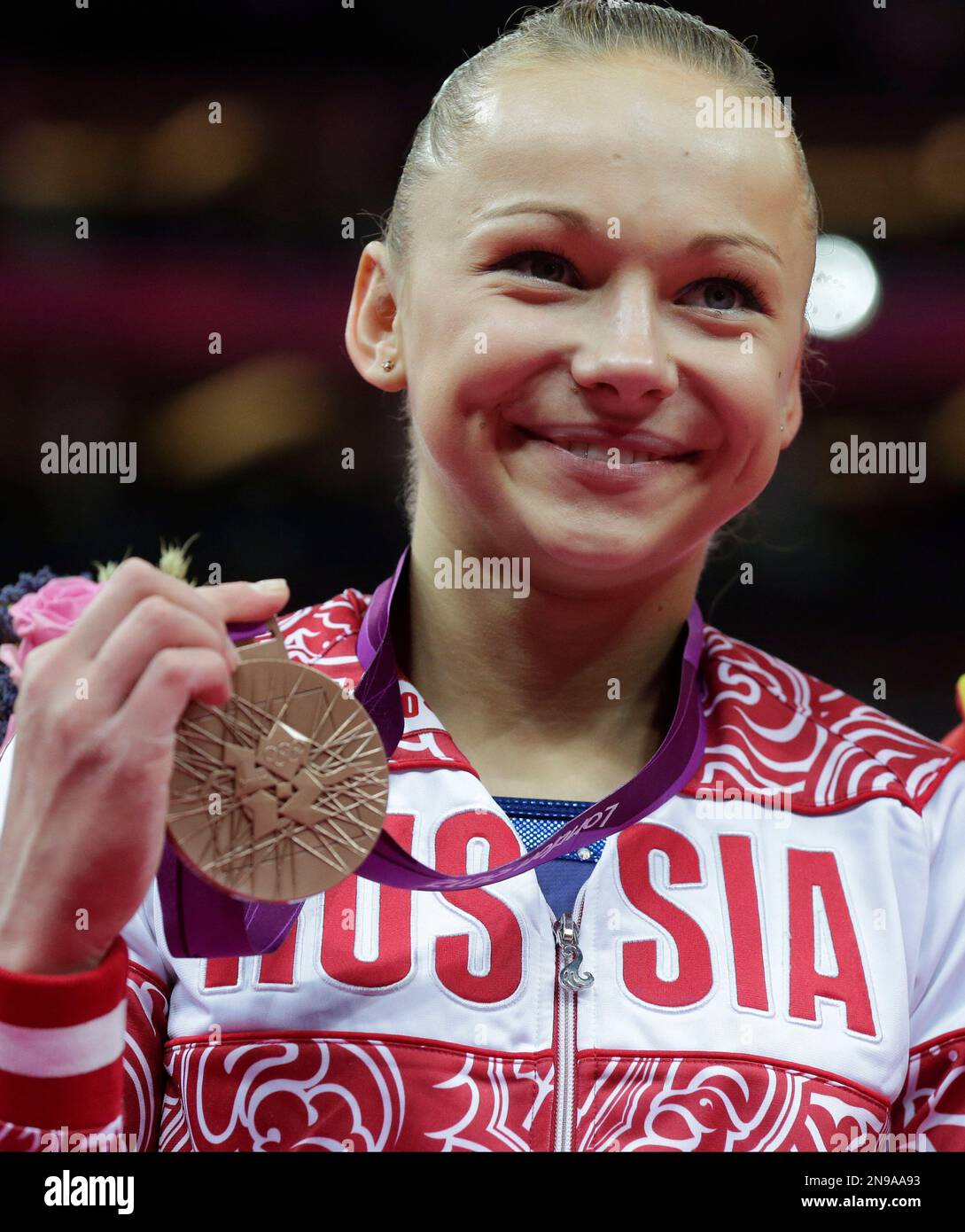 Russian gymnast Maria Paseka displays her bronze medal during the ...