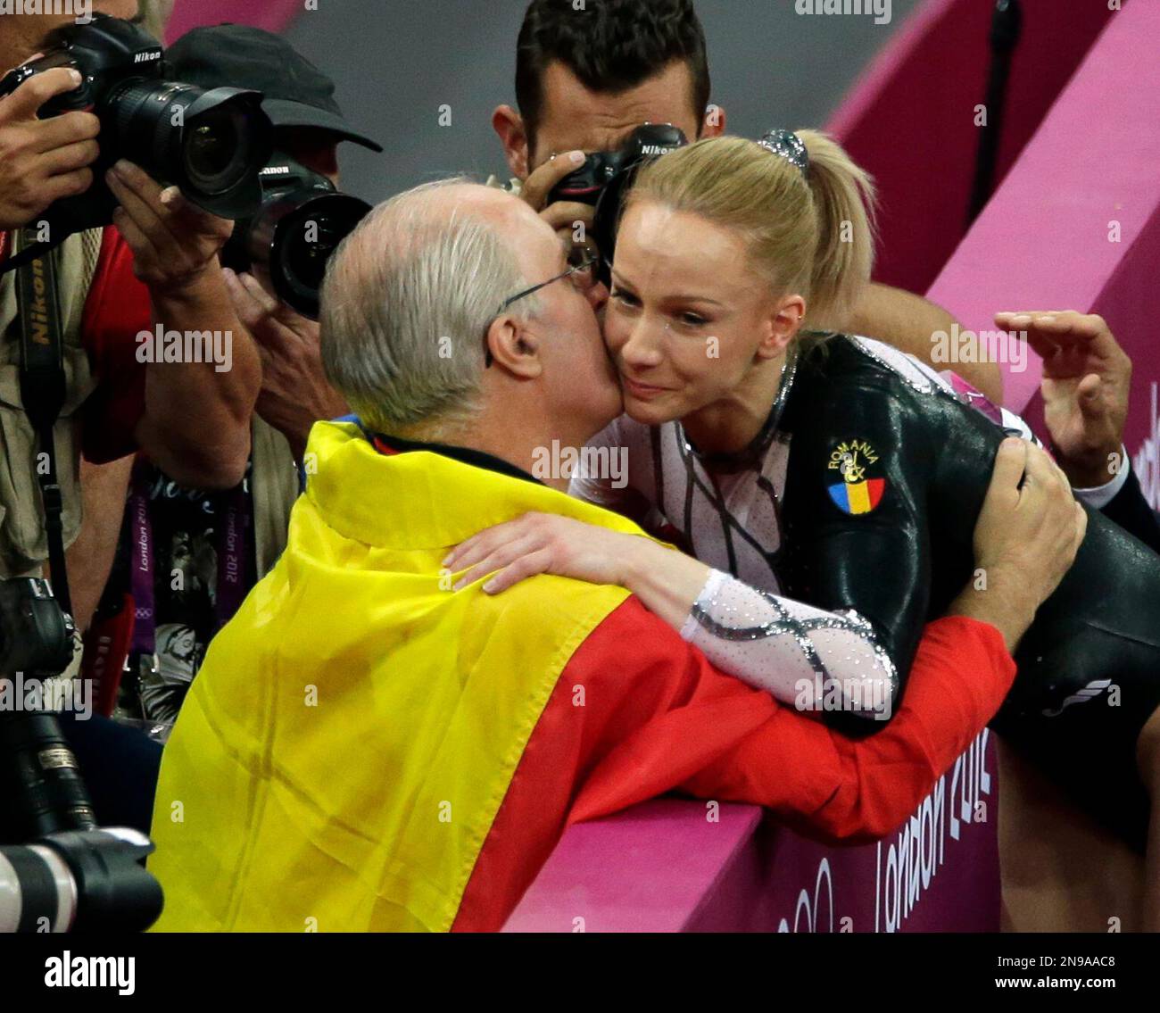 Romania's gymnast Sandra Raluca Izbasa hugs an unidentified person ...