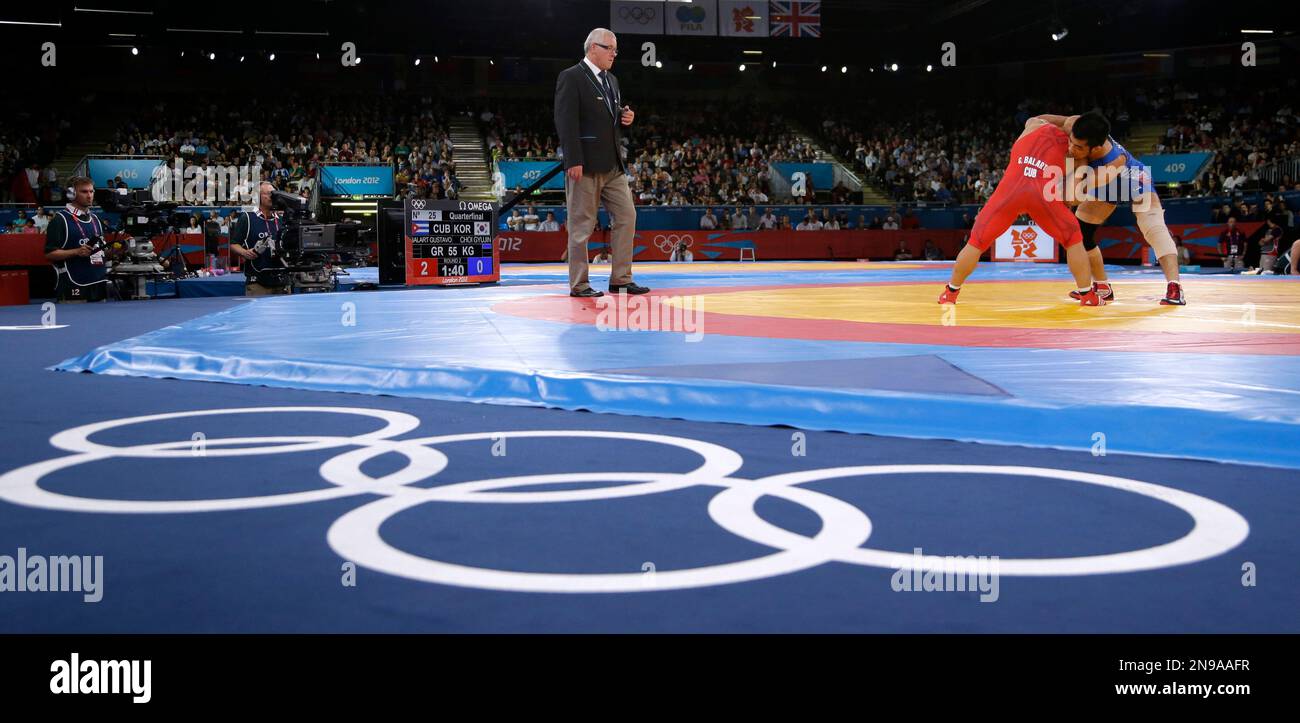 Cuba's Gustavo Balart, left, competes with South Korea's Choi Gyu-jin ...