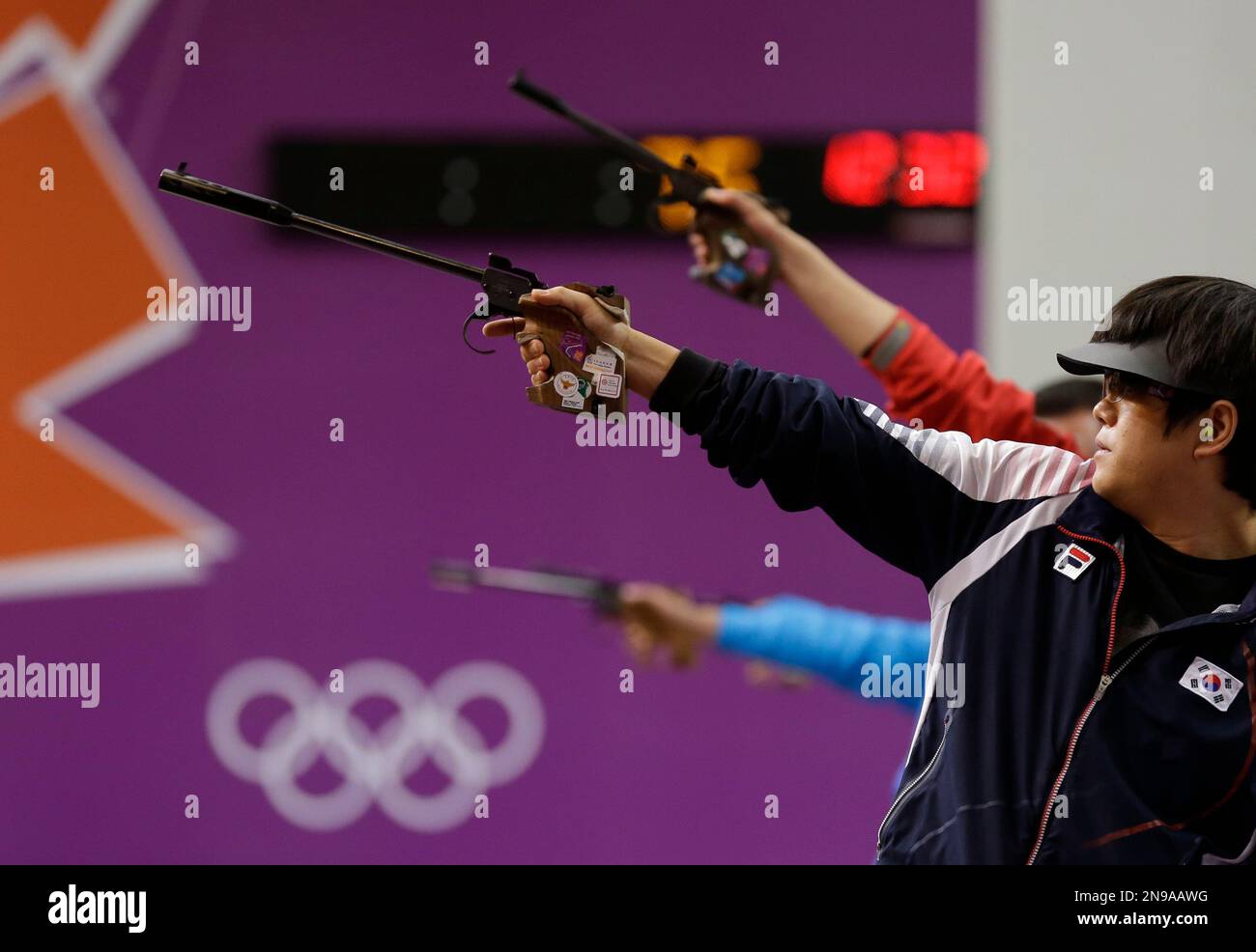 South Korea's Choi Young-rae shoots alongside competitors, in the men's ...