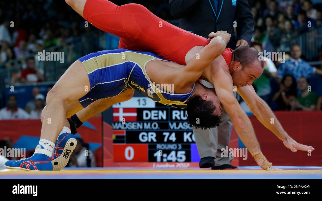 Denmark's Mark Overgaard Madsen, top, is flipped by Russia's Roman ...