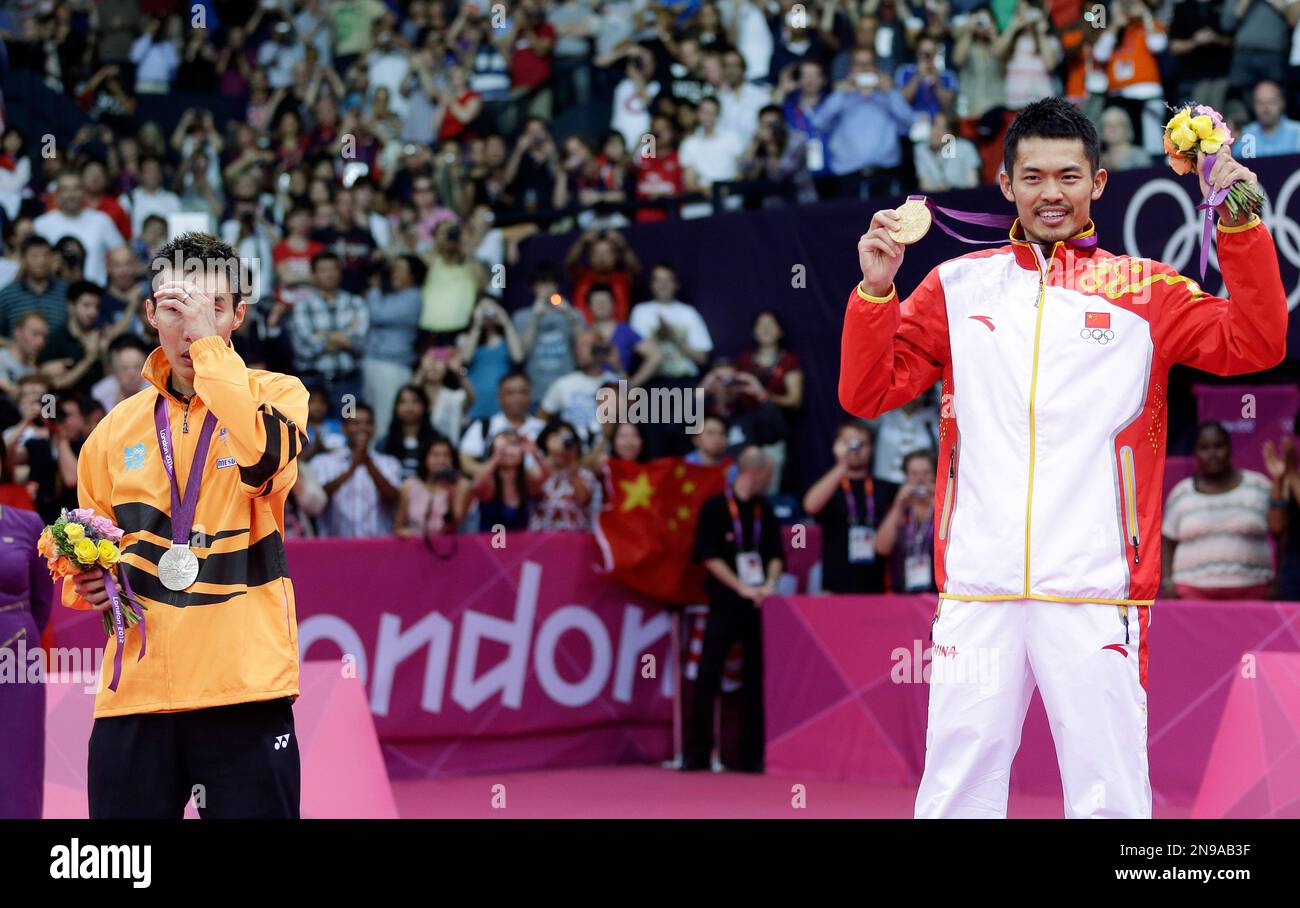 China's Lin Dan, right, shows his gold medal after winning the men's ...