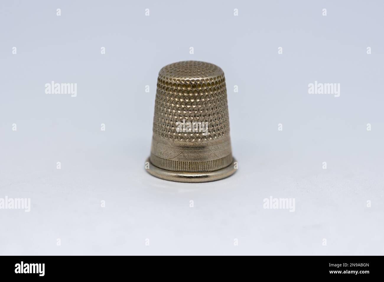 Vintage metal thimble isolated against a plain white background Stock ...