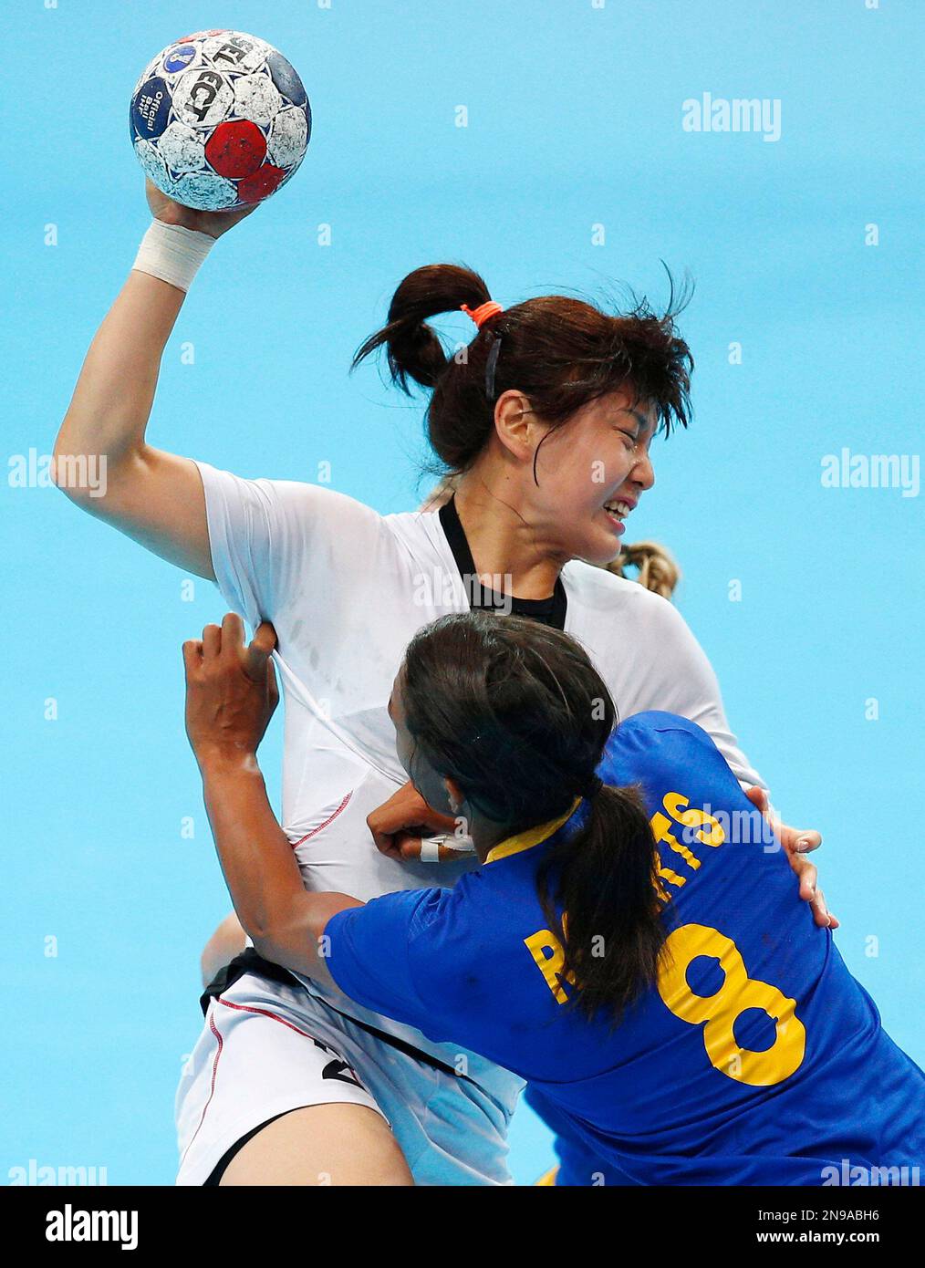 South Korea's Jung Ji-hae, background is tackled by Sweden's Jamina Roberts, foreground, during ...