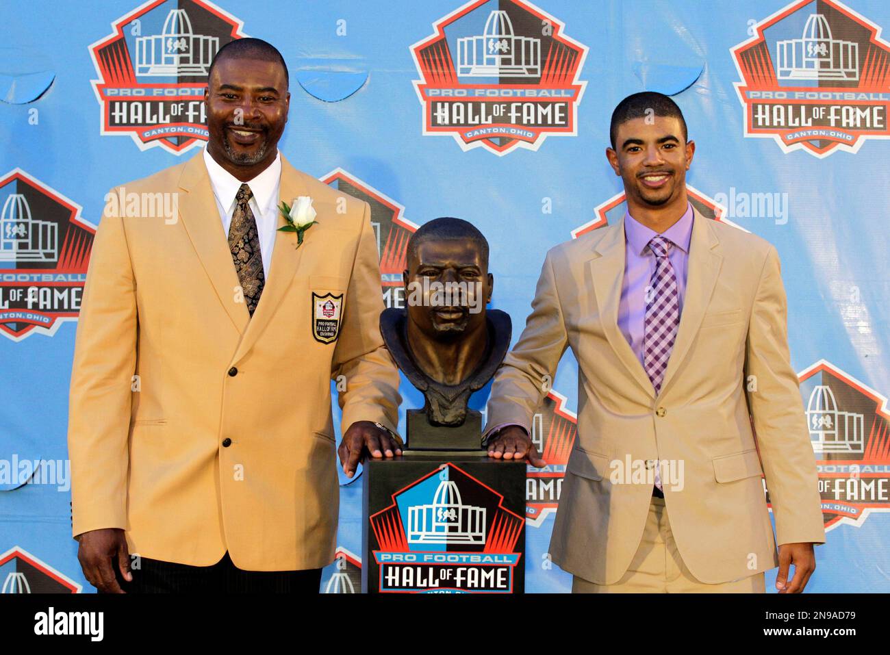 Former NFL player Chris Doleman, left, poses with a bust of himself and ...