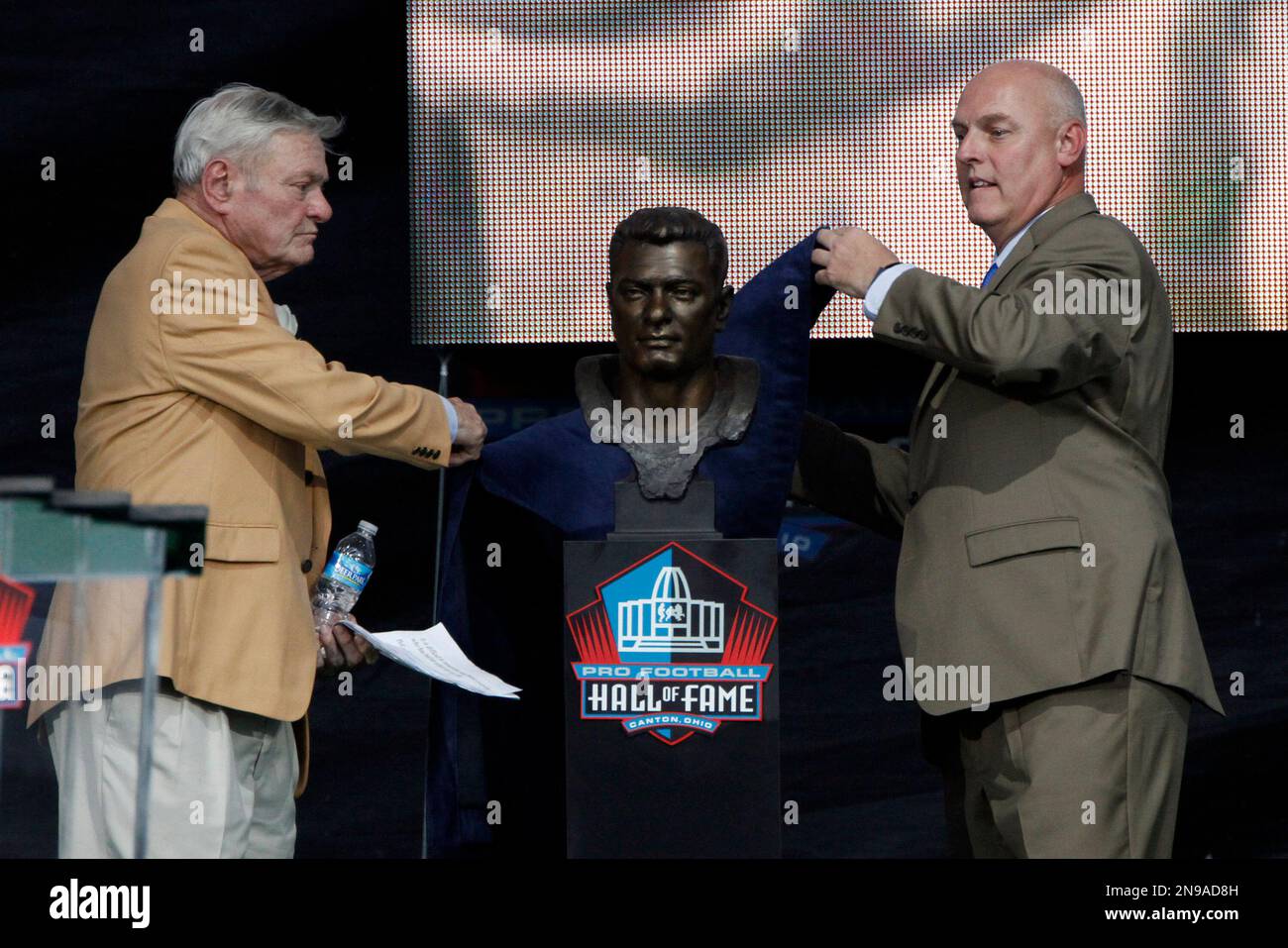 Former NFL player Jack Butler, left, unveils a bust of himself with ...