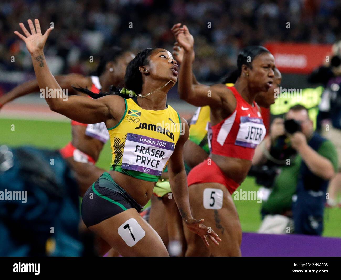 Gold medal winner, Jamaica's Shelly-Ann Fraser-Pryce, left, crosses the finish line ahead of ...