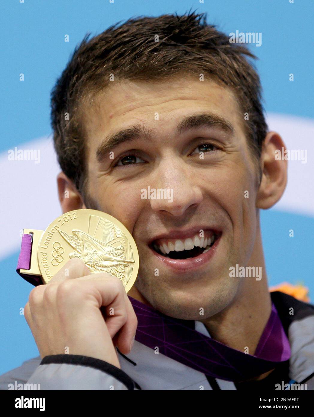 United States' swimmer Michael Phelps poses with his gold medal in the ...