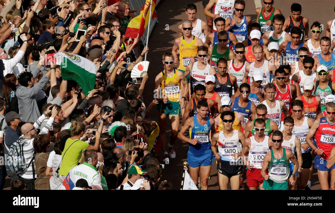 Athletes compete in the men's 20-kilometer race walk near Buckingham ...