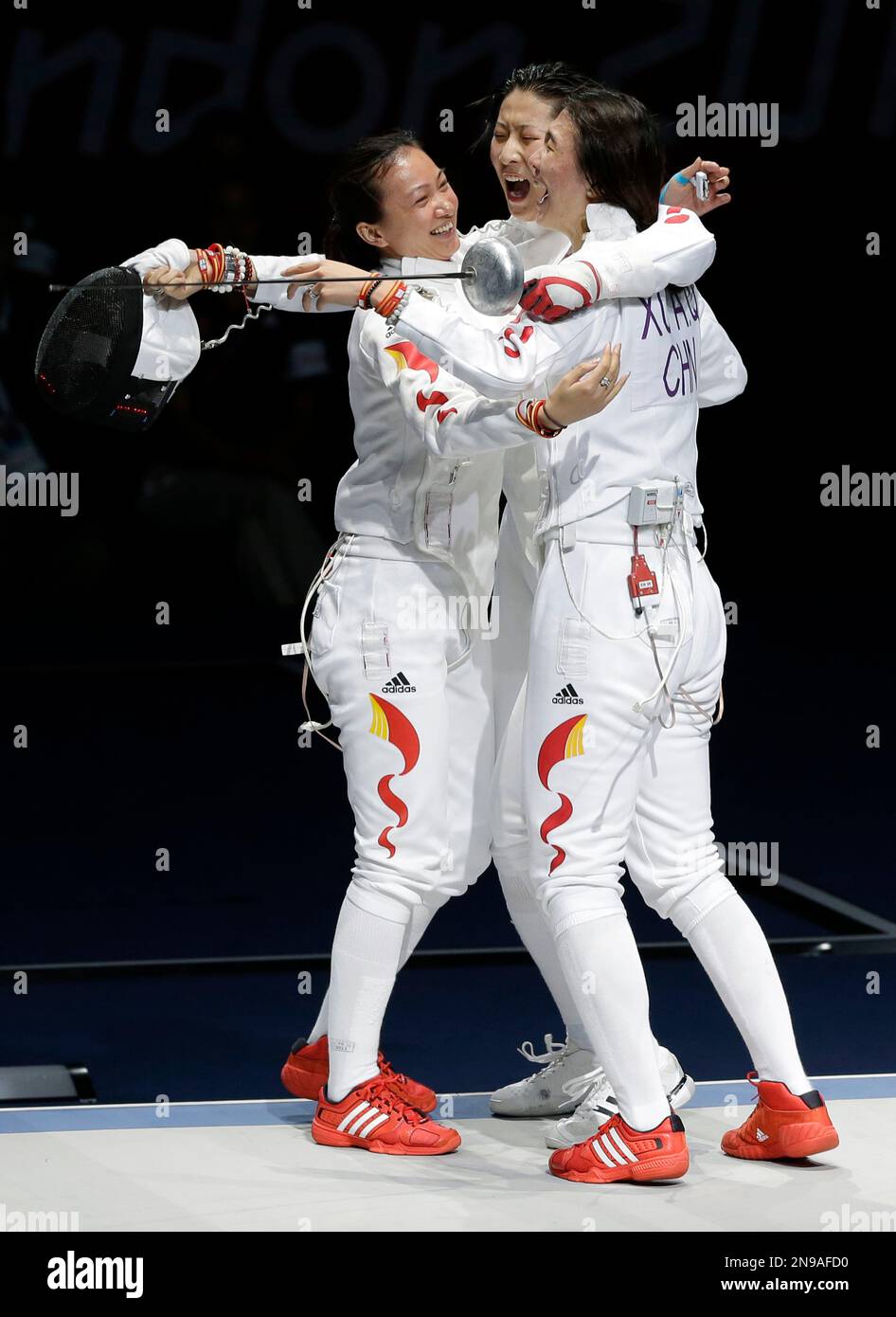 China's Sun Yujie, center, reacts with teammates after their team ...
