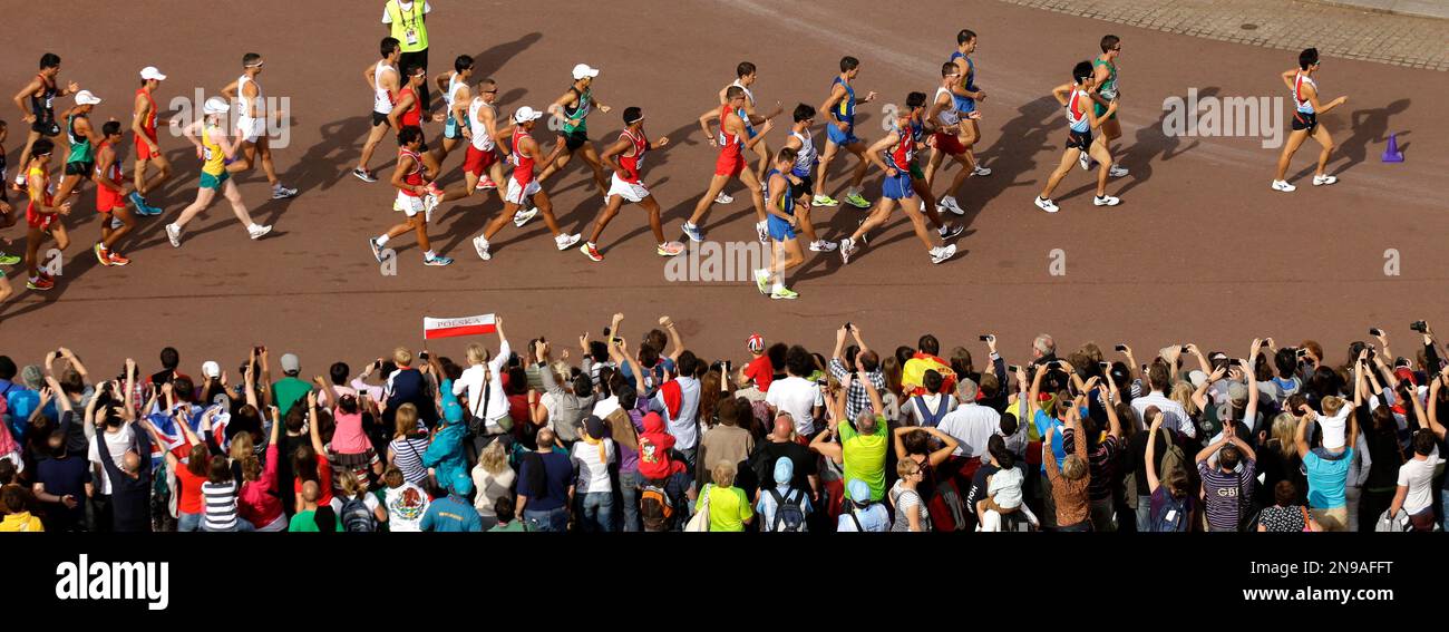 Athletes compete in the men's 20-kilometer race walk near Buckingham ...