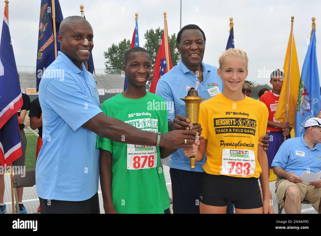 Olympic legends Carl Lewis and Rafer Johnson pose with the torch ...
