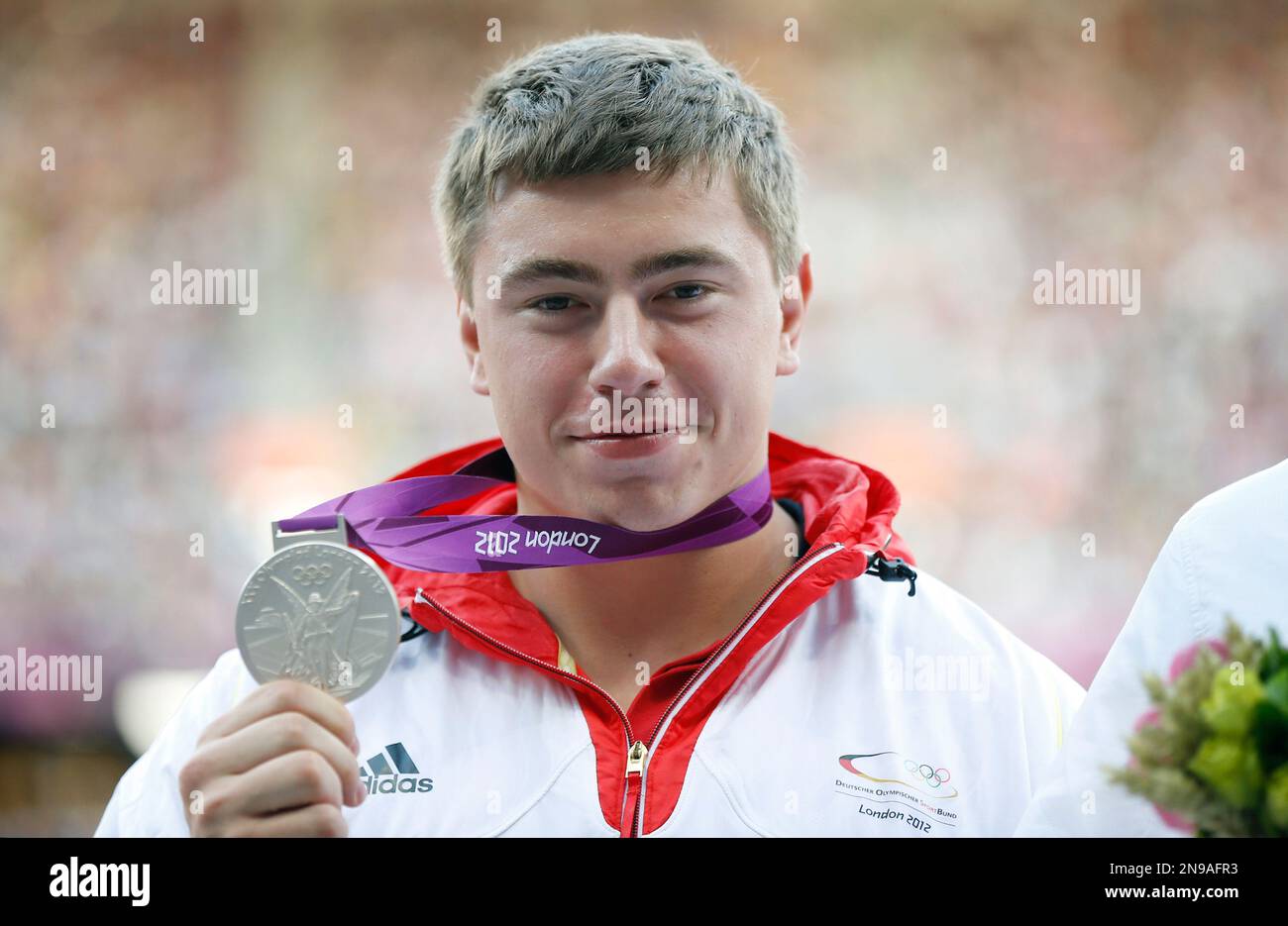 Germany's David Storl shows off his silver medal during the ceremony ...