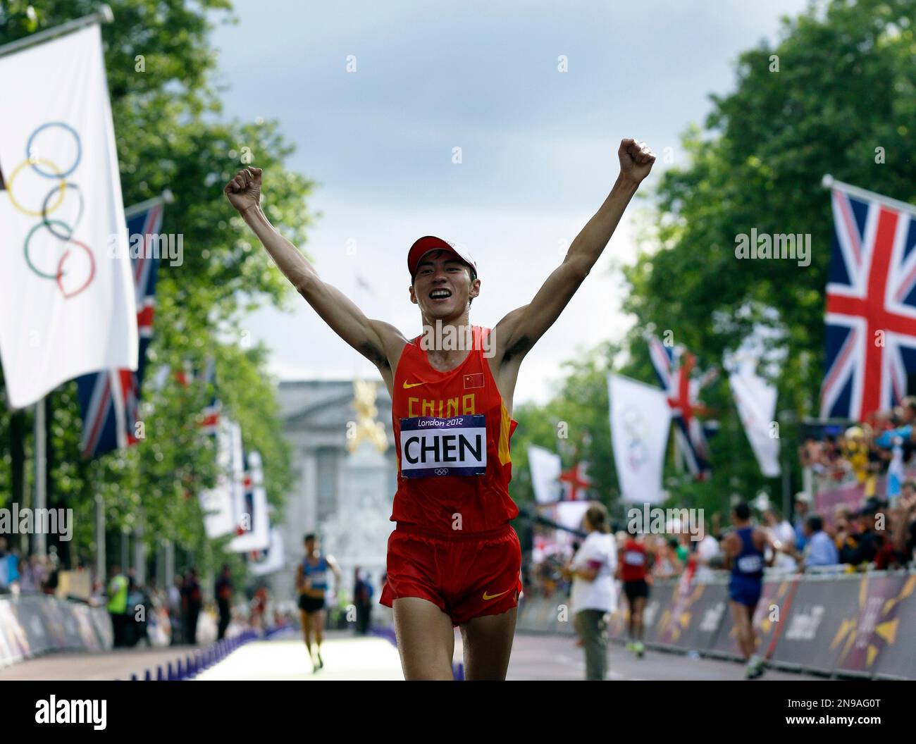 China's Chen Ding celebrates as he crosses the finish line to win the ...