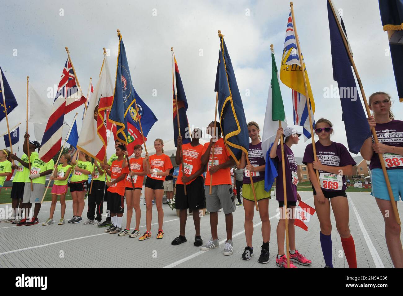Competitors display flags during opening remarks at the 35th birthday ...