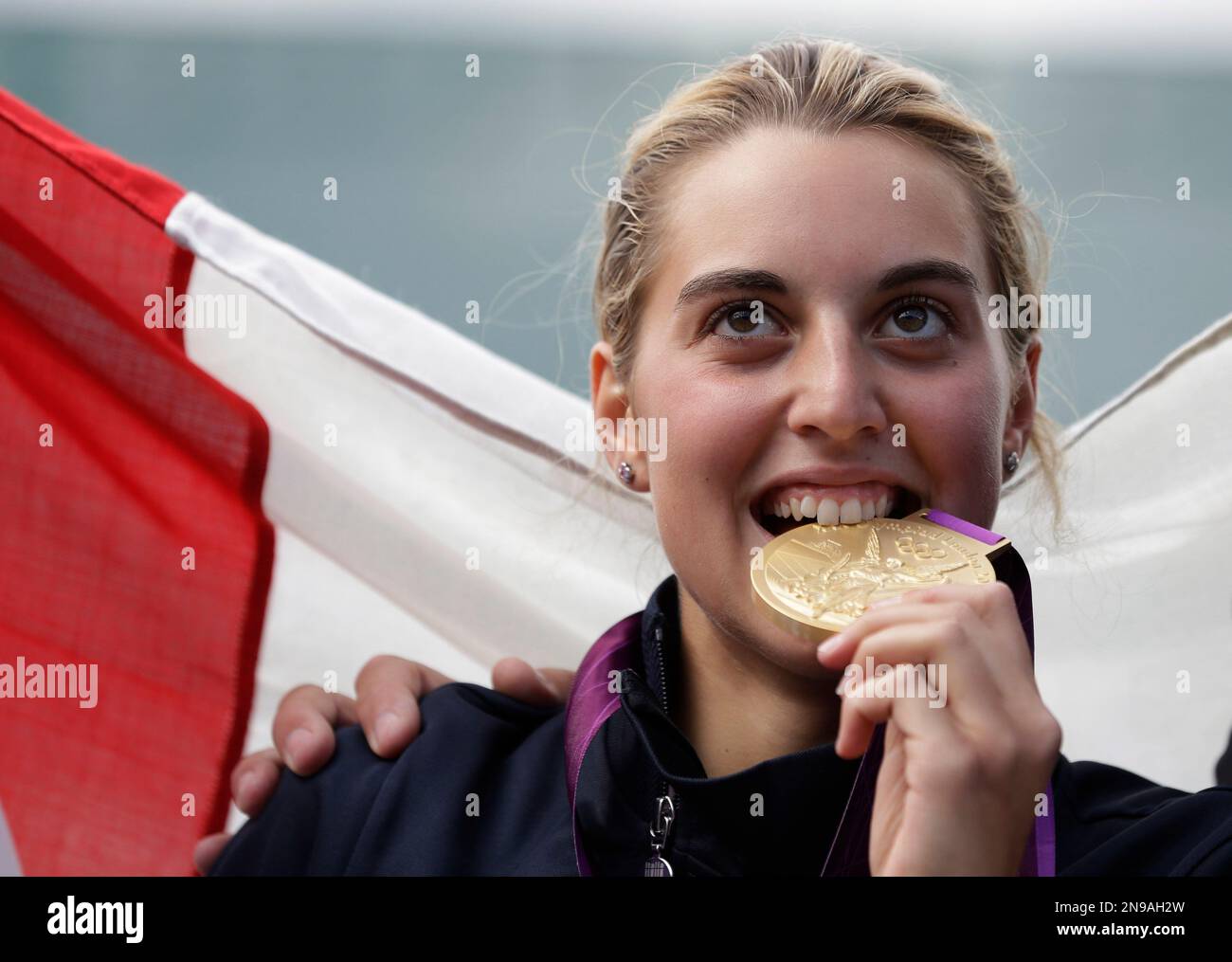 Italy's Jessica Rossi bites her gold medal, following the victory ...