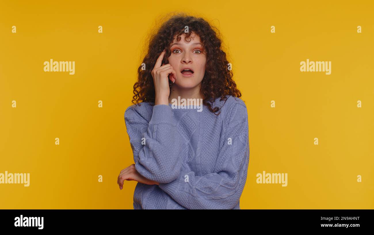 Eureka. Inspired woman pointing finger up with open mouth, having good ...