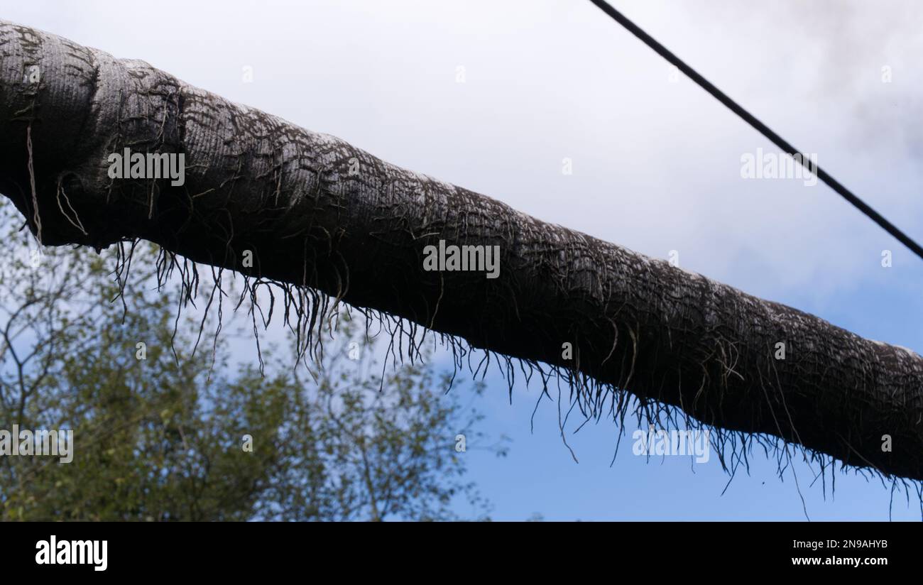 Pipe covered with old material that's fraying Stock Photo - Alamy