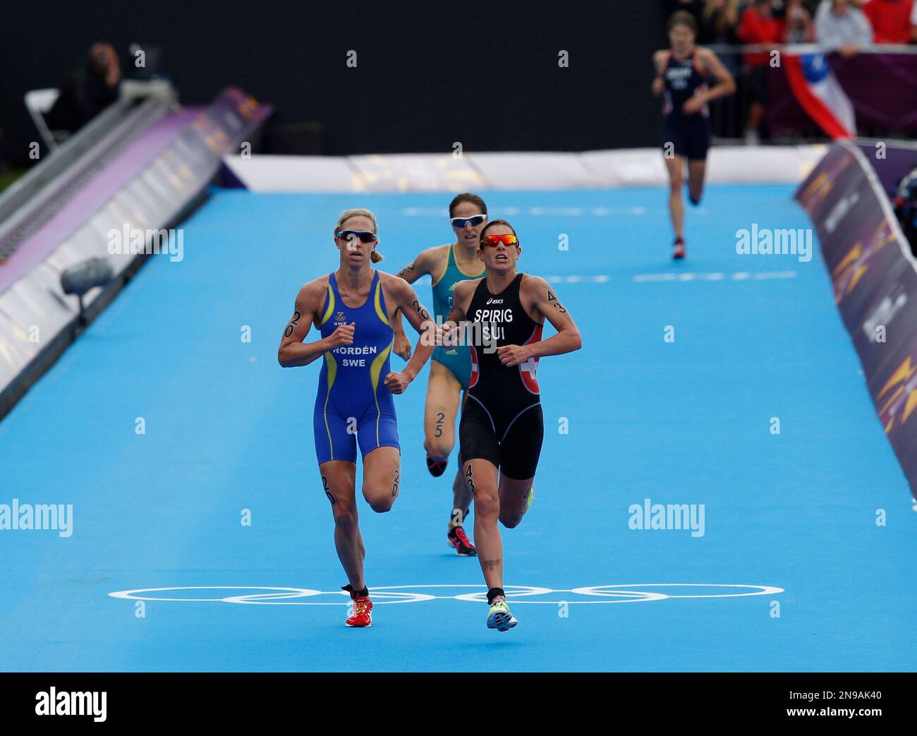 Switzerland's Nicola Spirig, right, Sweden's Lisa Norden, left, and ...