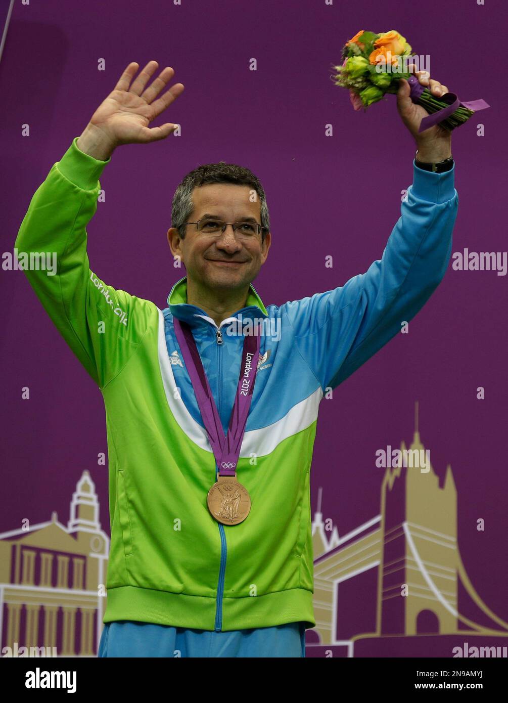 Slovenia's Rajmond Debevec celebrates his bronze medal in the men's 50 ...