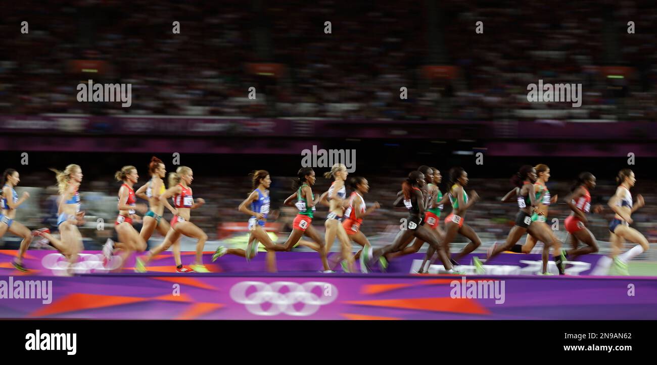Athletes compete in the women's 10,000-meter final during the athletics ...