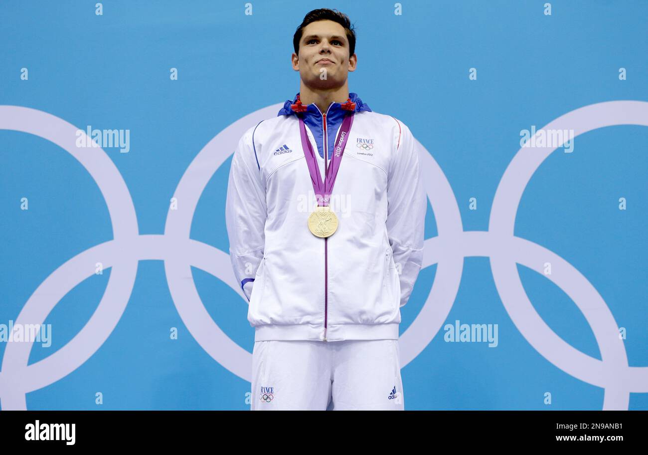 France's Florent Manaudou holds his gold medal in the men's 50-meter ...