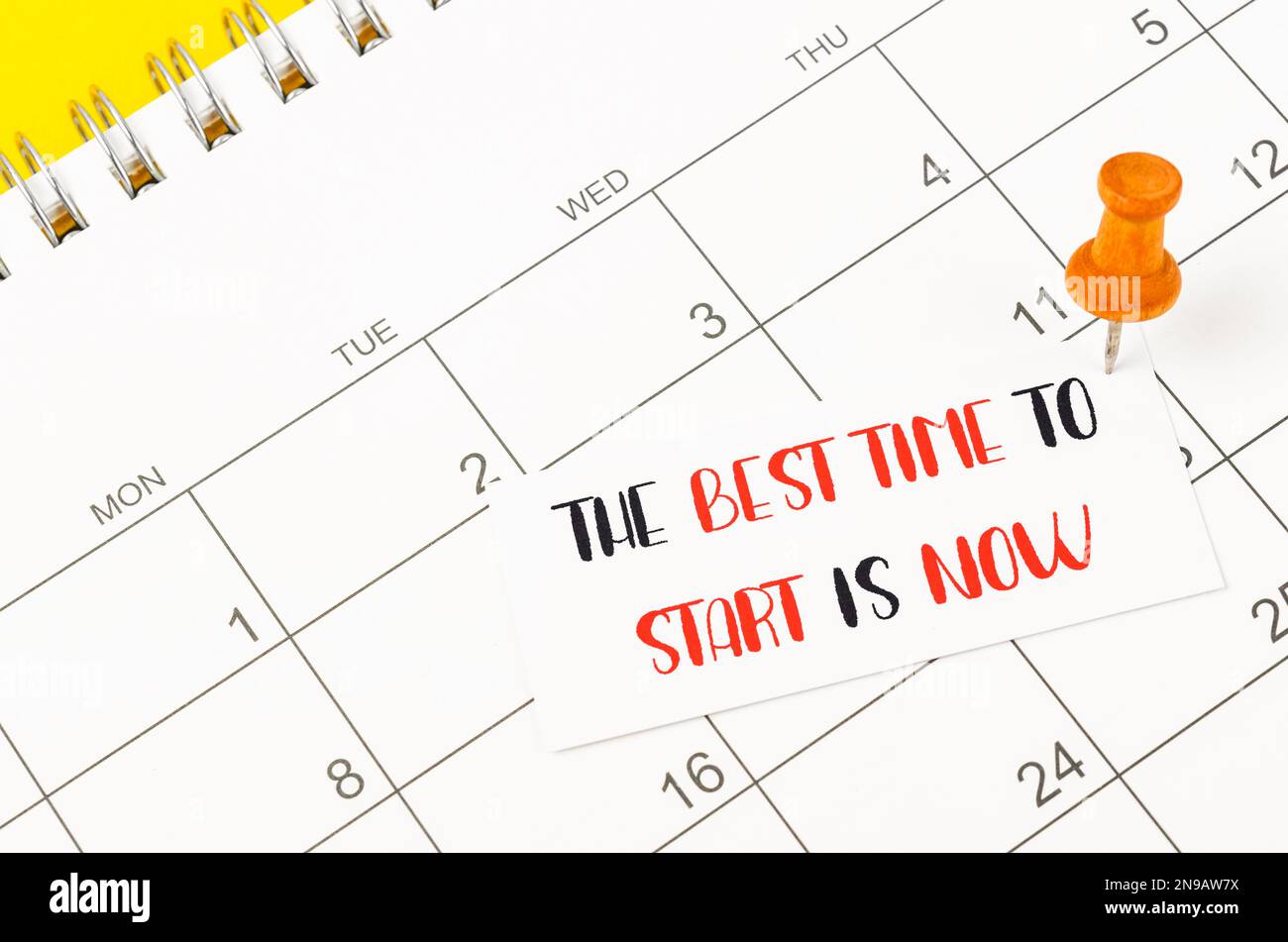The word "Best time to start is now" and wood push pin on calendar page ...