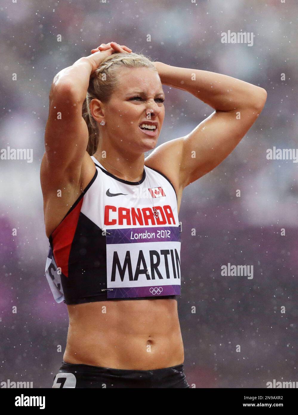 Canada's Jenna Martin stands in the puring rain during a women's 400 ...