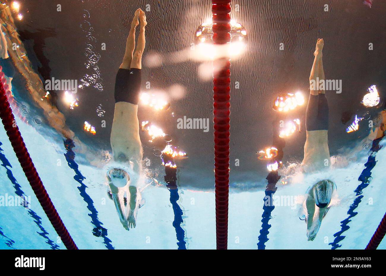 China's Sun Yang, left, and Denmark's Pal Joensen dive in for the start ...
