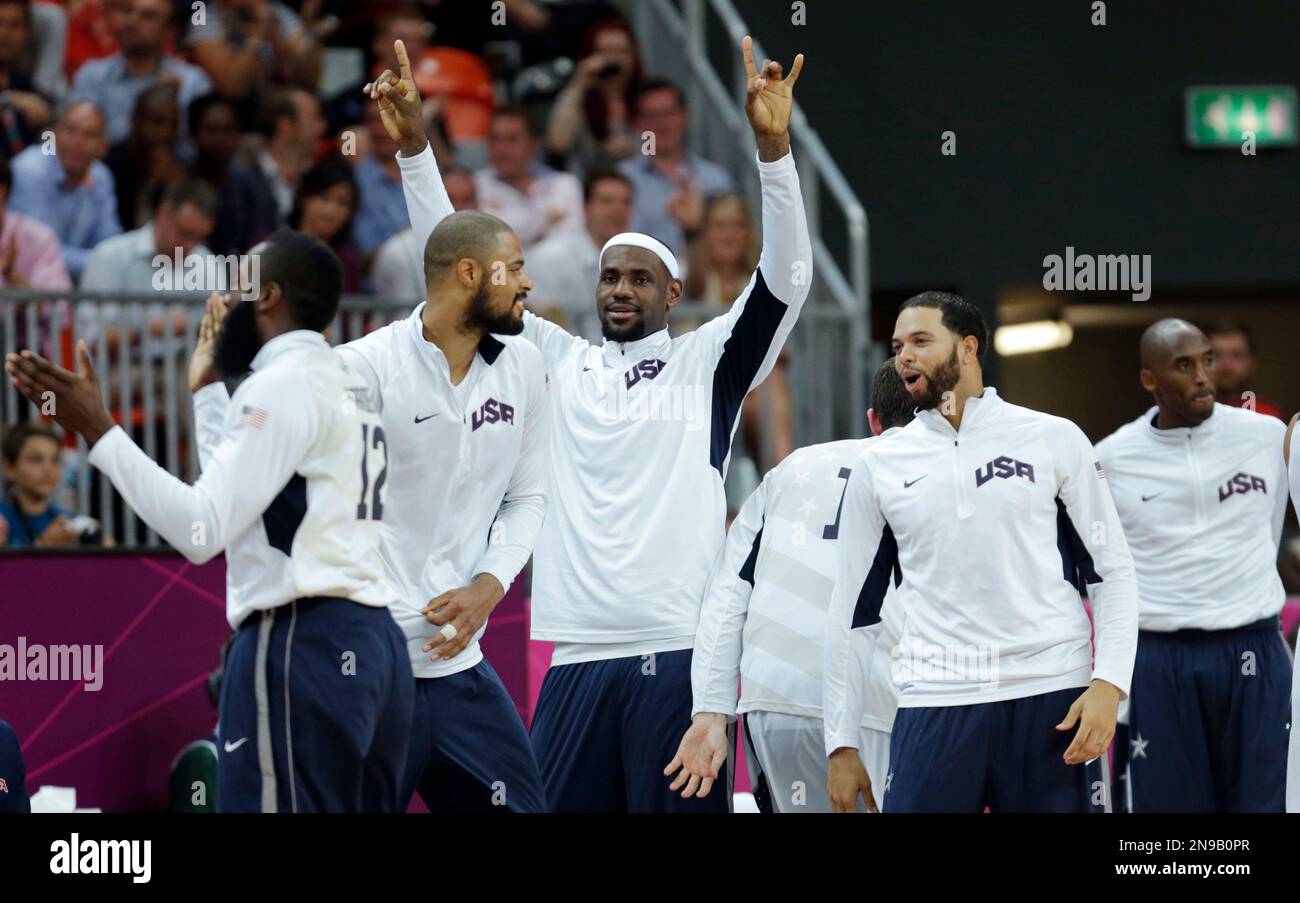 USA's Lebron James raises his arms as team he celebrates with teammates ...