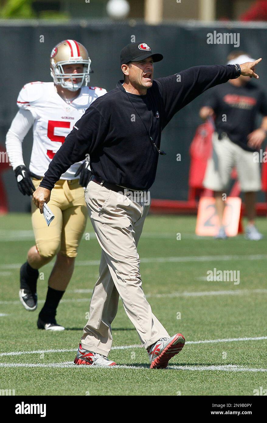 San Francisco 49ers head coach Jim Harbaugh yells during practice at an ...