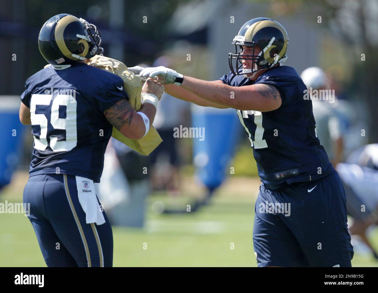 St. Louis Rams linebacker Rocky McIntosh (59) drills with tackle Joe ...