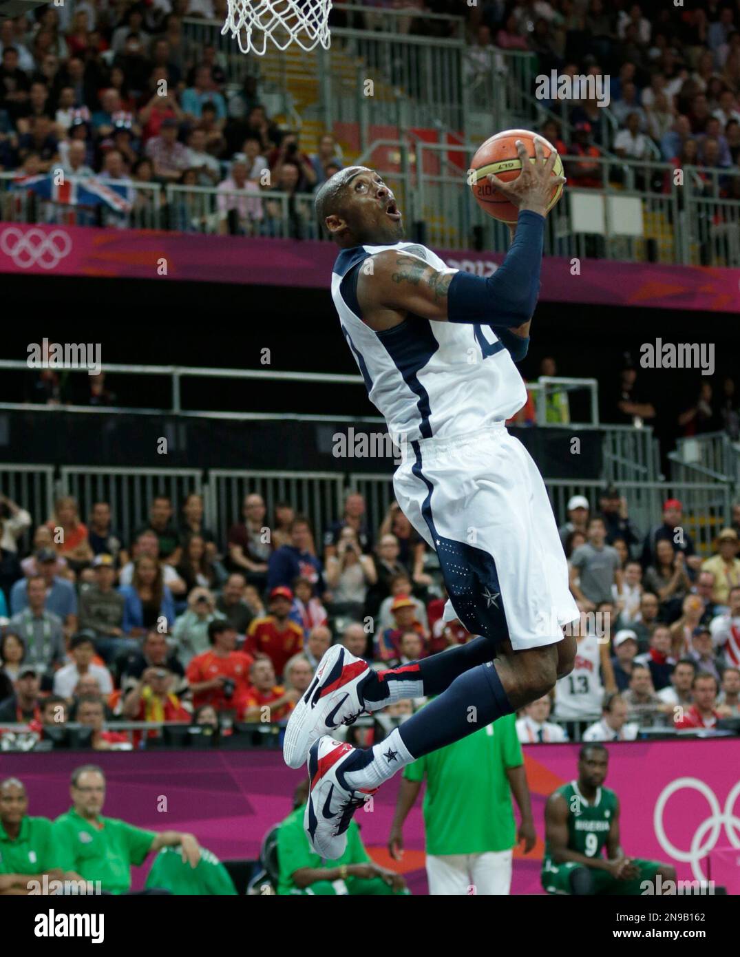 USA's Kobe Bryant looks backwards as he lines up a reverse dunk against ...