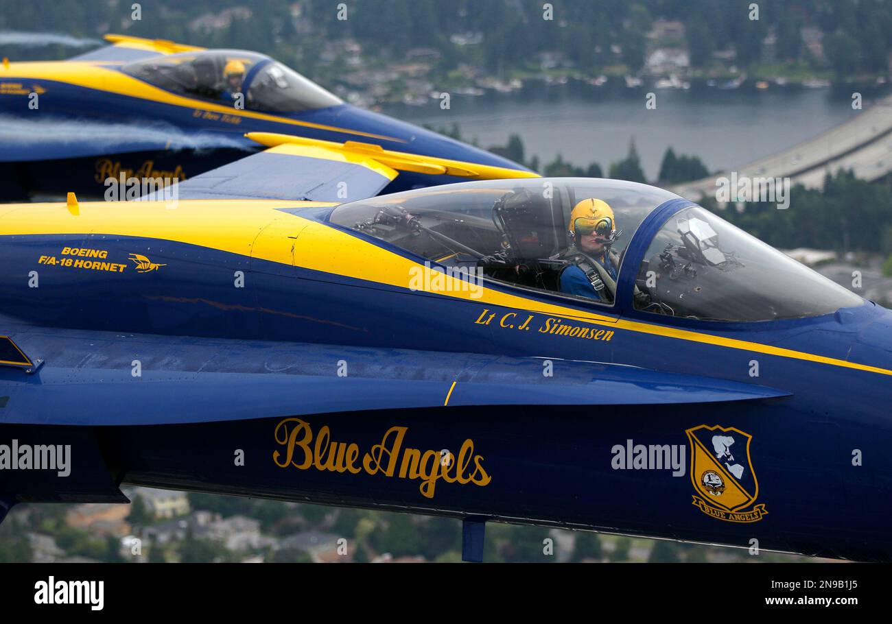 U.S. Navy Blue Angels pilots Lt. C.J. Simonsen, right, and Lt. David Tickle, upper left, fly in ...
