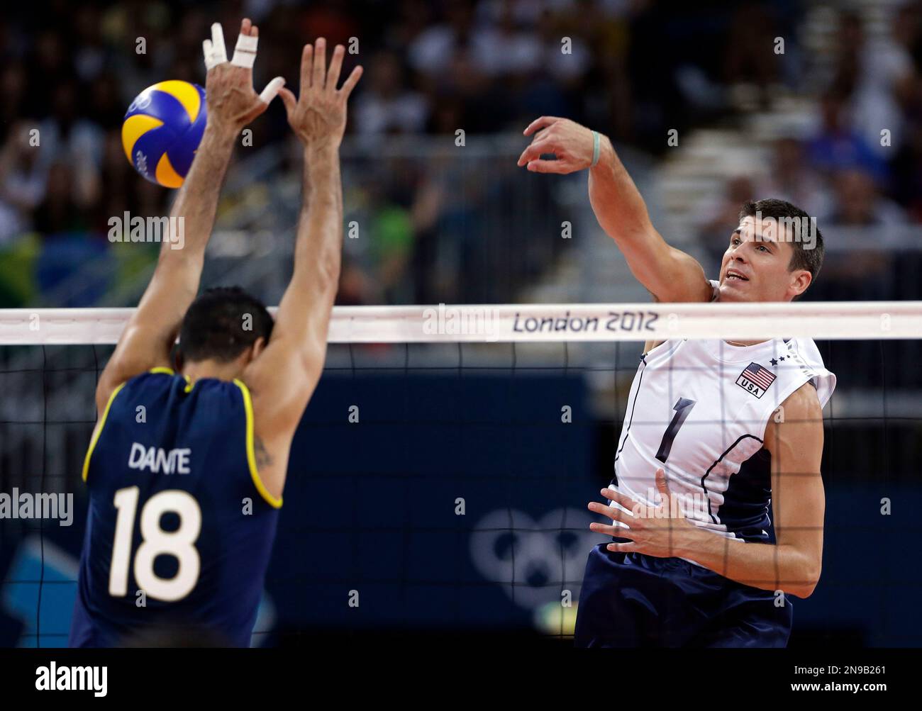 United States' Matthew Anderson, right, spikes the ball past Brazil's ...