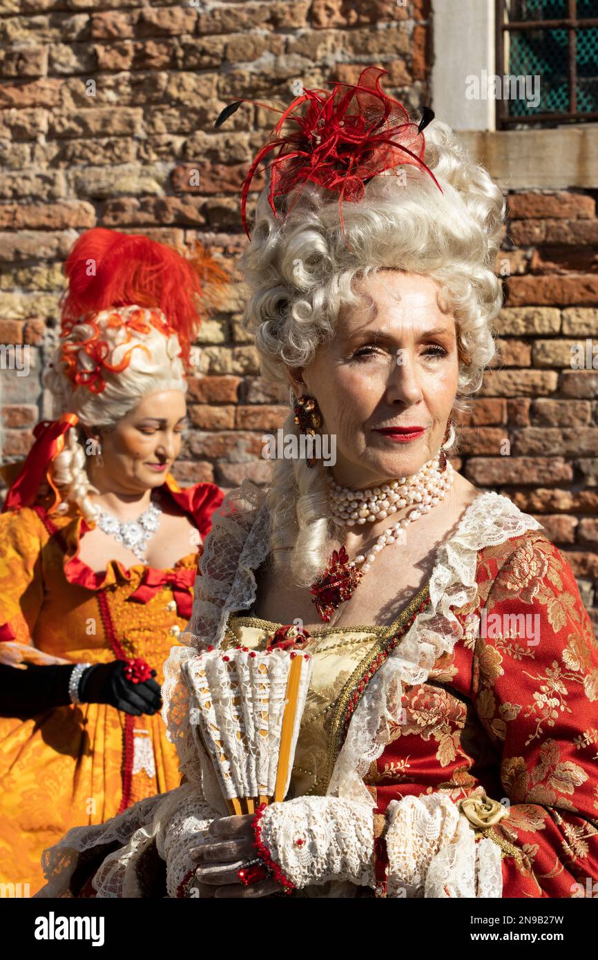 12. February 2023. Venice, Italy. Venetian revellers wear colourful ...