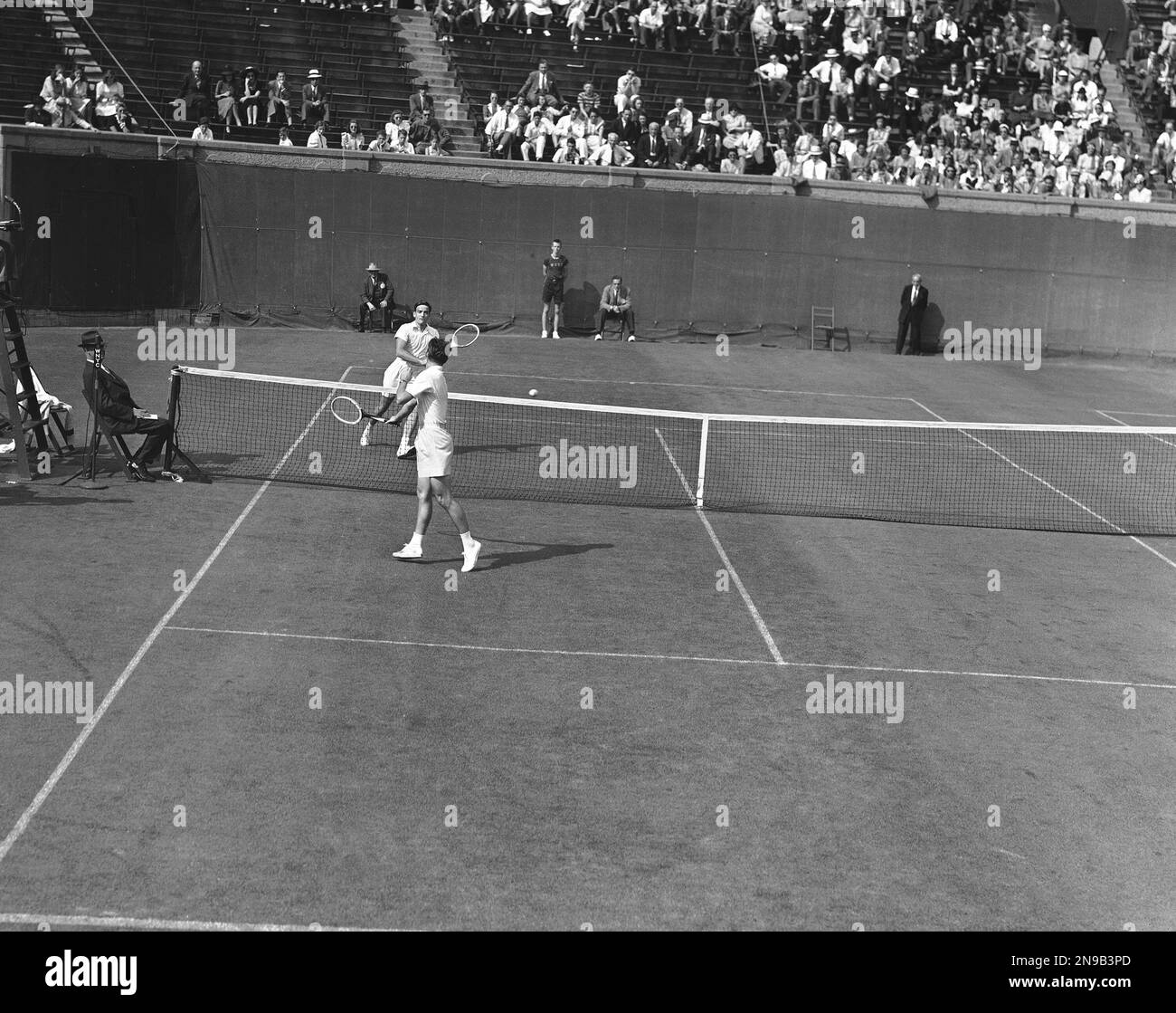 Bobby Riggs of Chicago, foreground, is shown as he began the defense of ...