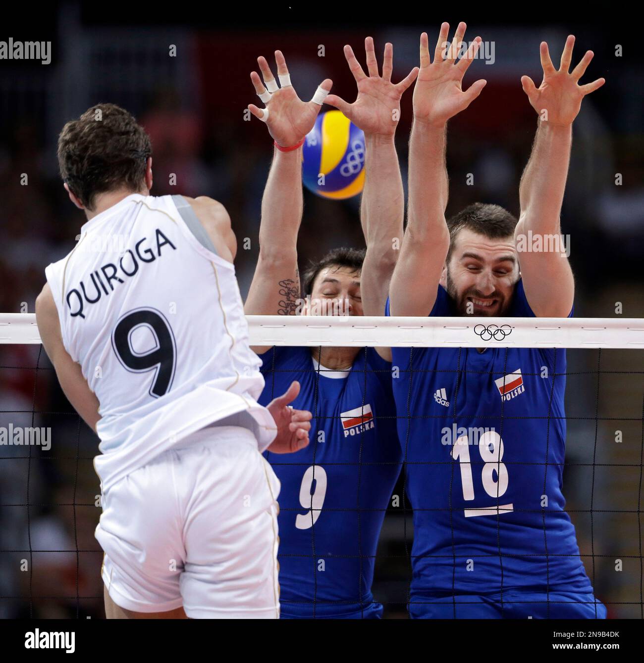 Argentina's Rodrigo Quiroga, left, spikes the ball past Poland's ...