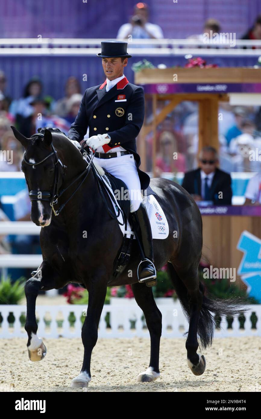 Carl Hester from Great Britain rides Uthopia in the equestrian dressage ...