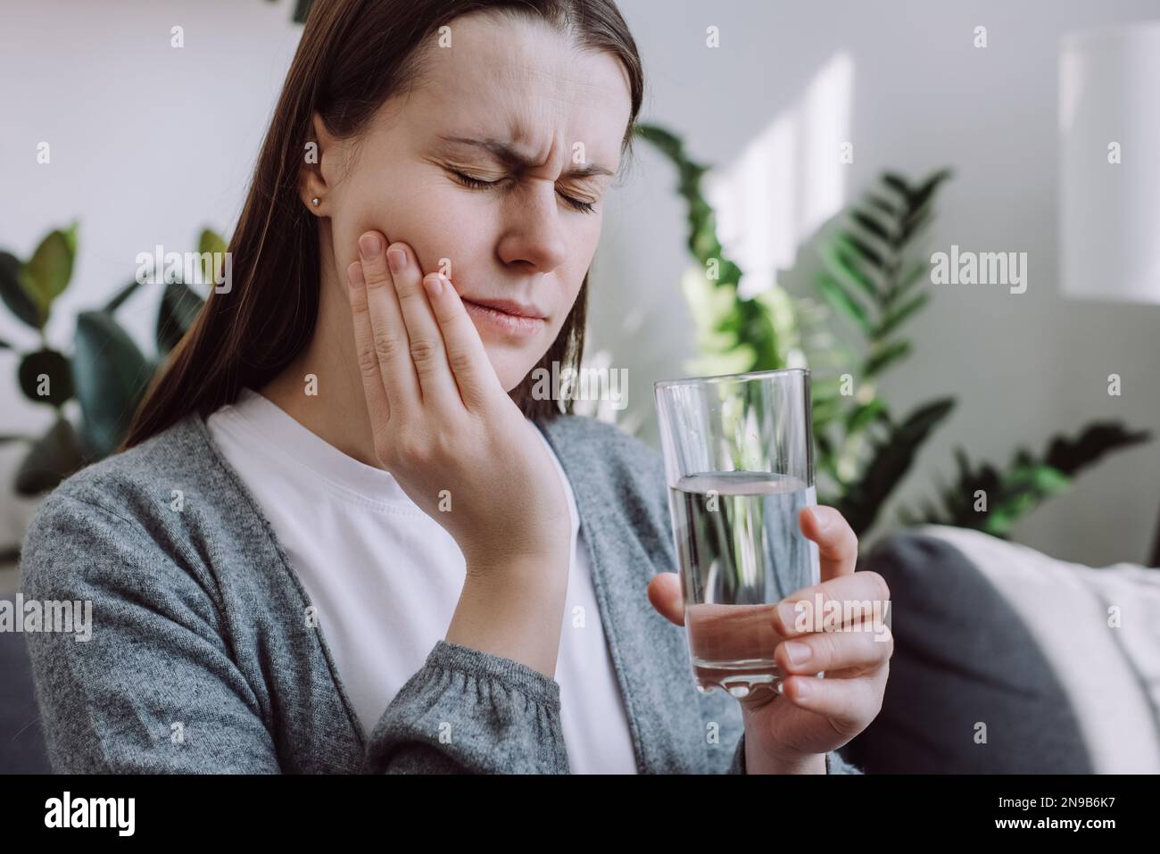 Portrait of young woman feel terrible toothache after drink cold water ...