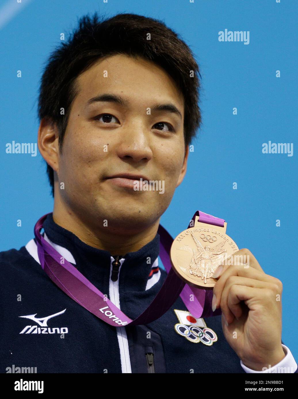 Japan's Ryo Tateishi poses with his bronze medal for the men's 200-meter breaststroke swimming ...