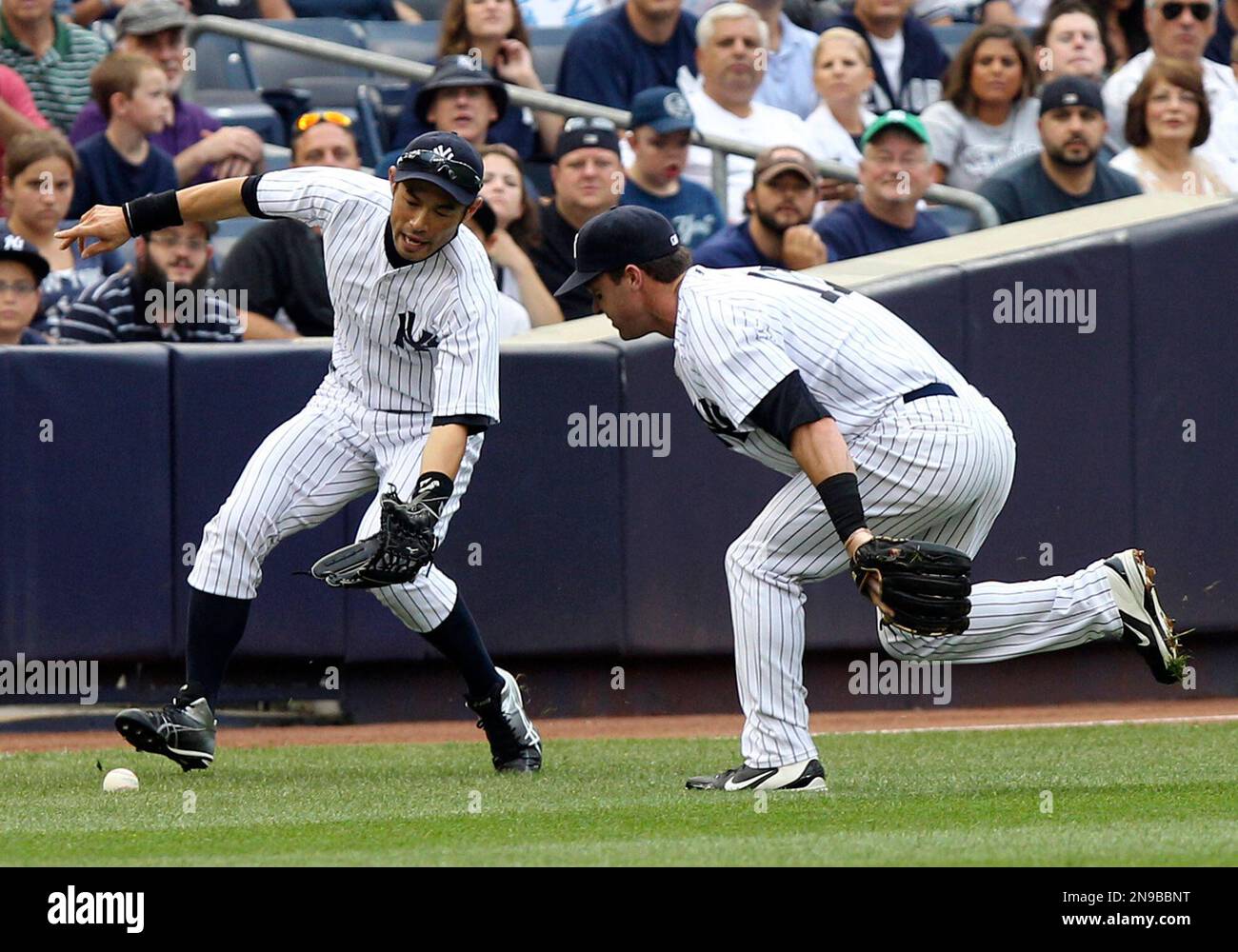 New York Yankees' Ichiro Suzuki, left, and Jayson Nix chase after a ...