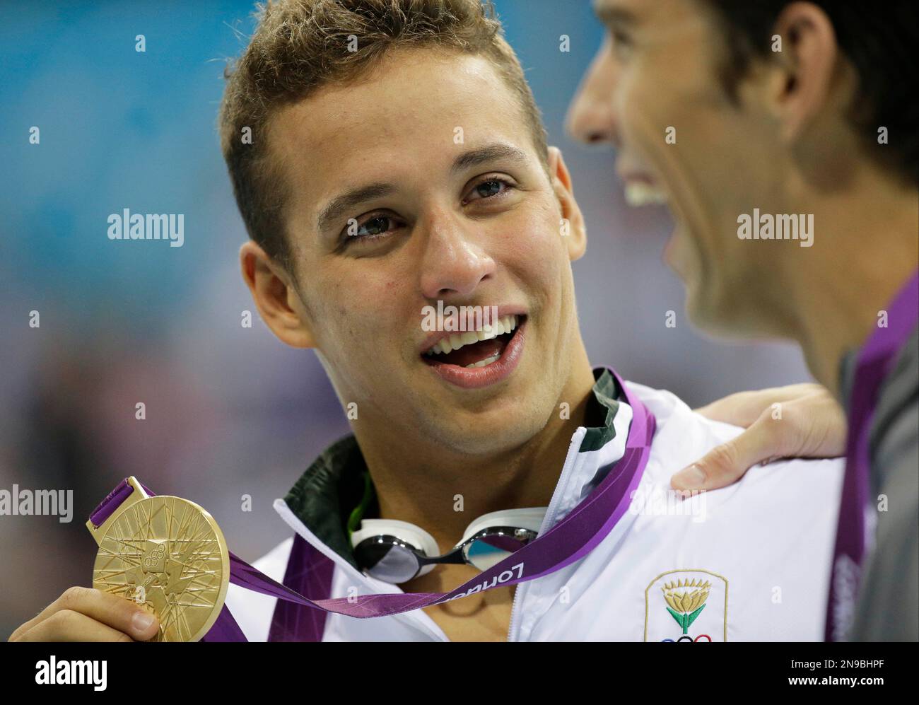 South Africa's Chad le Clos poses with his gold medal for the men's 200 ...