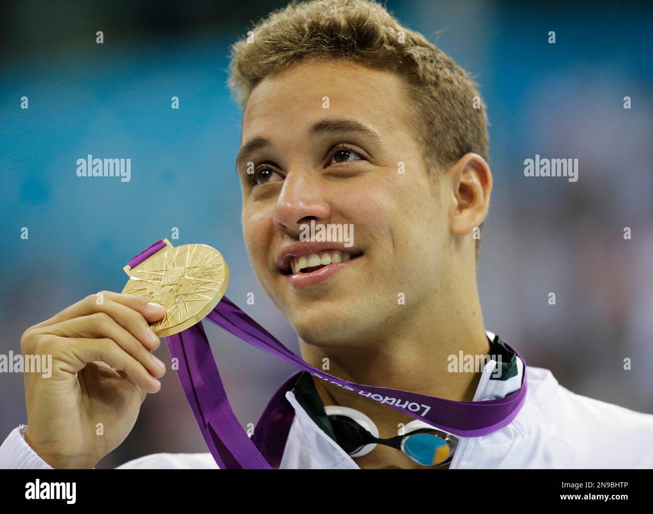 South Africa's Chad le Clos poses with his gold medal for the men's 200 ...