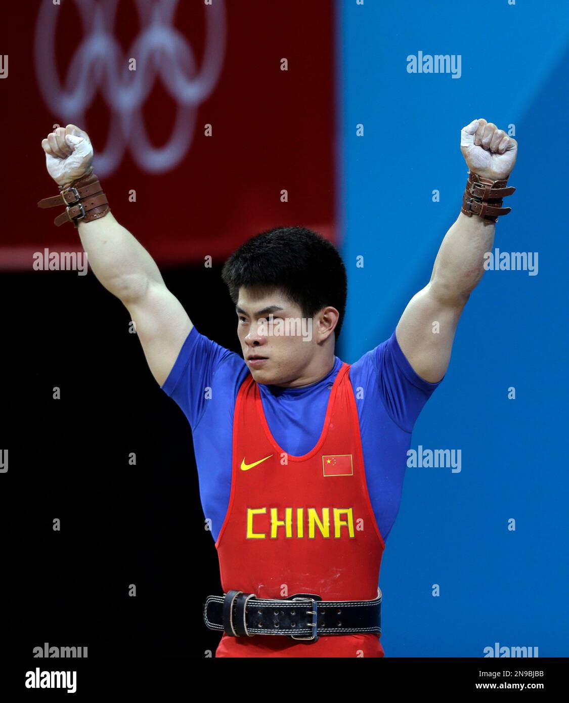 Lin Qingfeng celebrates his gold medal win in the men's 69-kg, group A ...