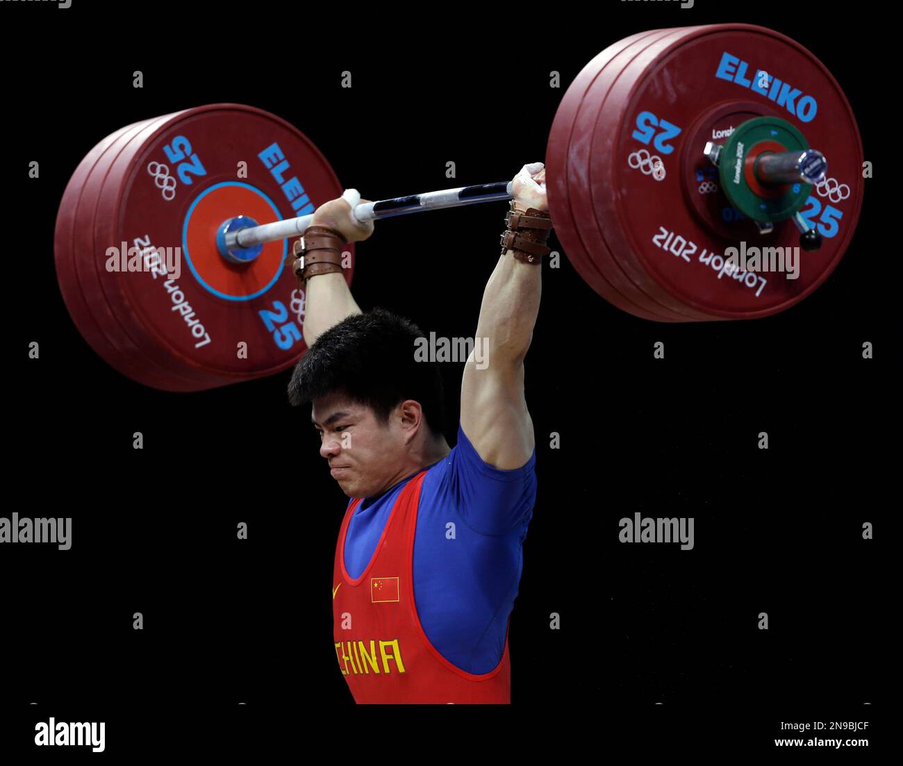 Lin Qingfeng of China competes during the men's 69-kg weightlifting ...