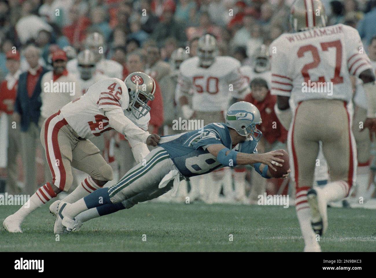 San Francisco 49ers Ronnie Lott pulls down Seattle Seahawks receiver ...