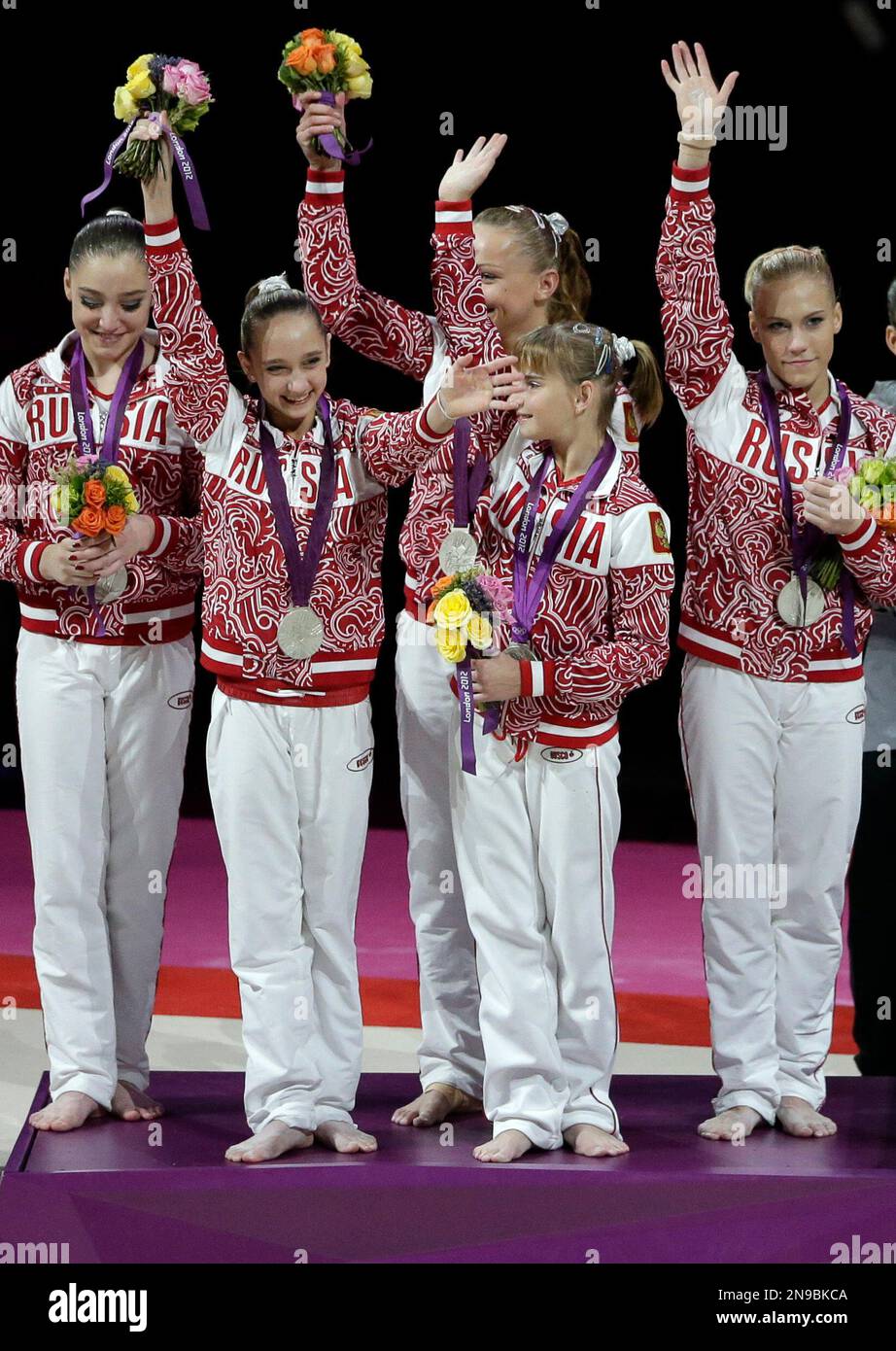 Russian gymnasts, left to right, Aliya Mustafina, Victoria Komova ...
