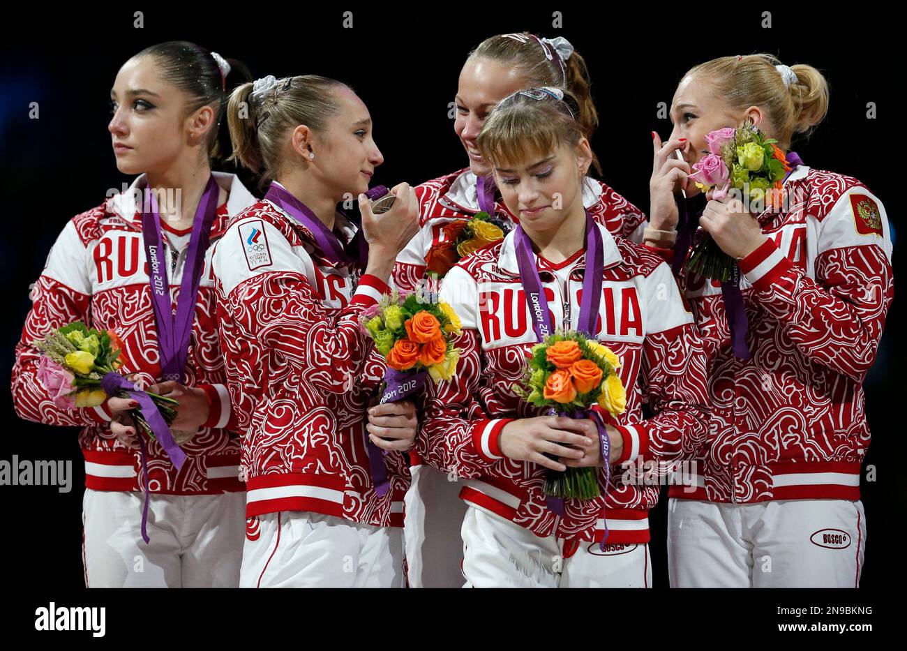 Russian gymnasts, left to right, Aliya Mustafina, Victoria Komova ...
